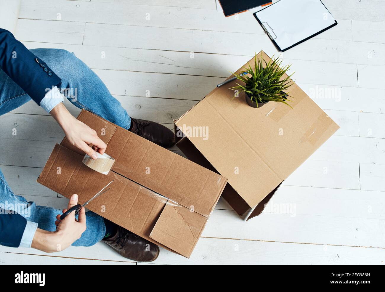 Man packing boxes moving office professional official Stock Photo - Alamy