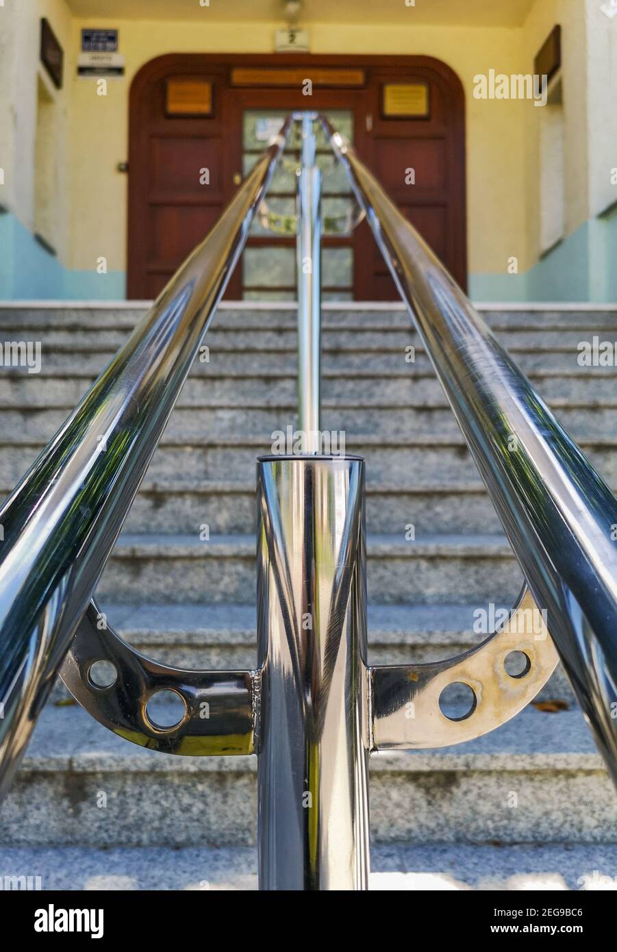 Metal chrome railing at stairs to the building with wooden doors Stock ...