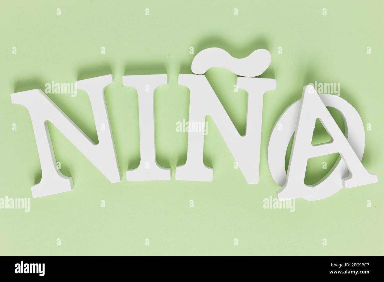 Top view of Spanish "NINO", "NINA" writing isolated on a green ...