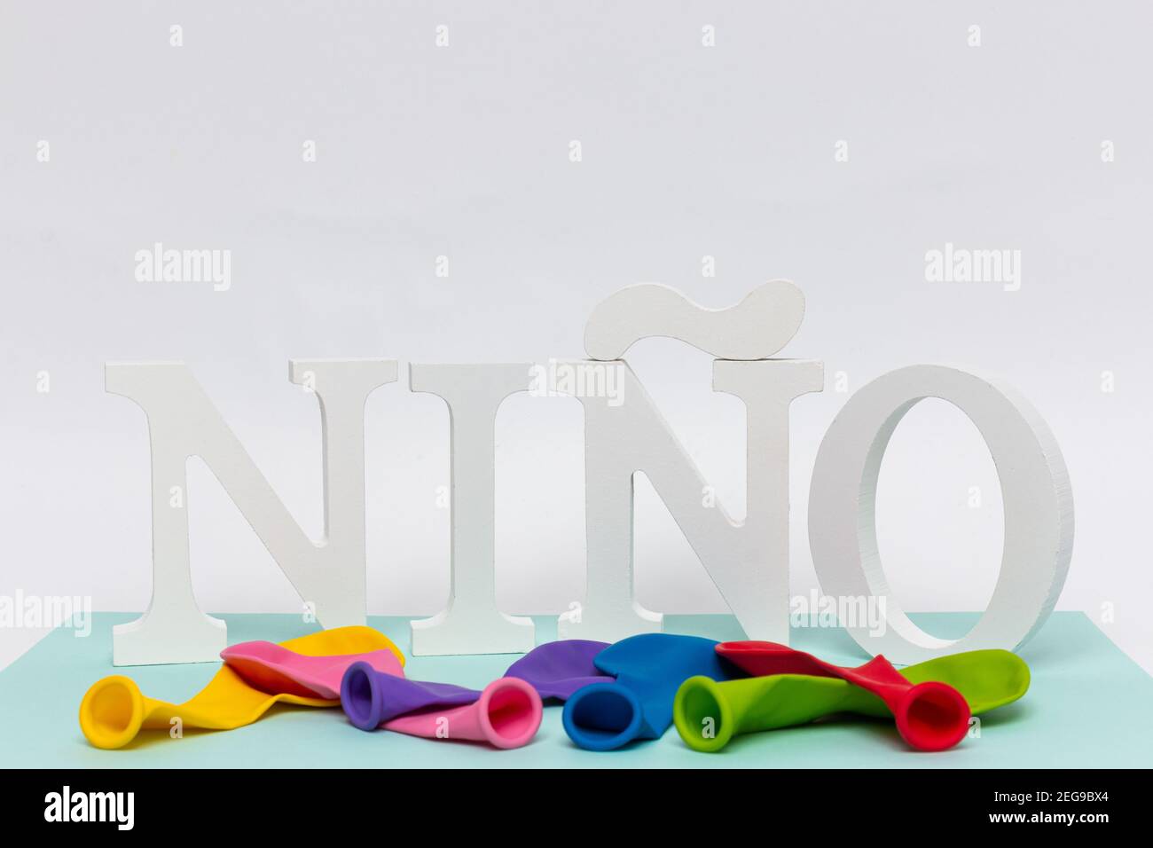 Beautiful background with Spanish "NINO" writing and colorful balloons ...