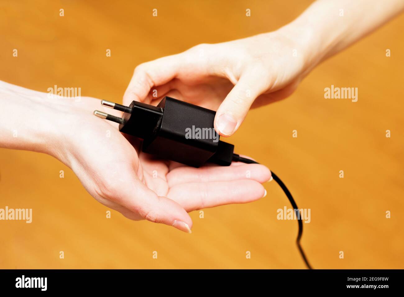 The process of hand-to-hand transfer of a smartphone charger Stock ...