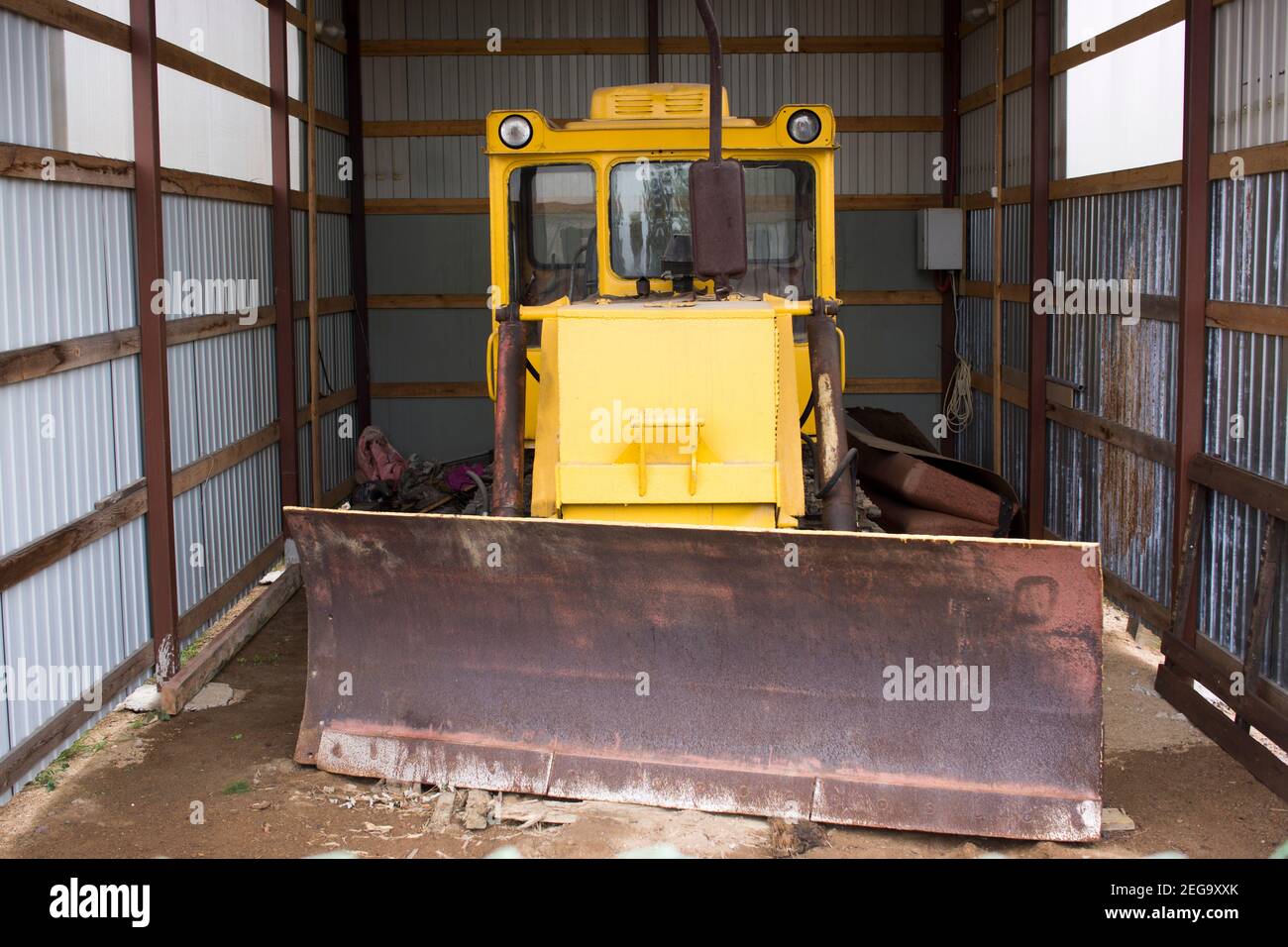 Large wheeled tractor with a dozer blade for clearing roads from snow ...