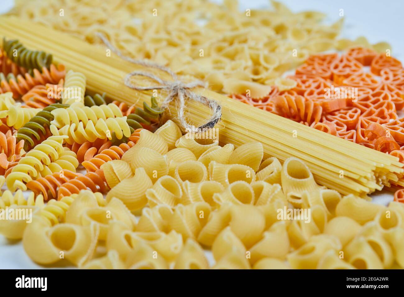 Various forms of dry pasta on blue background Stock Photo - Alamy