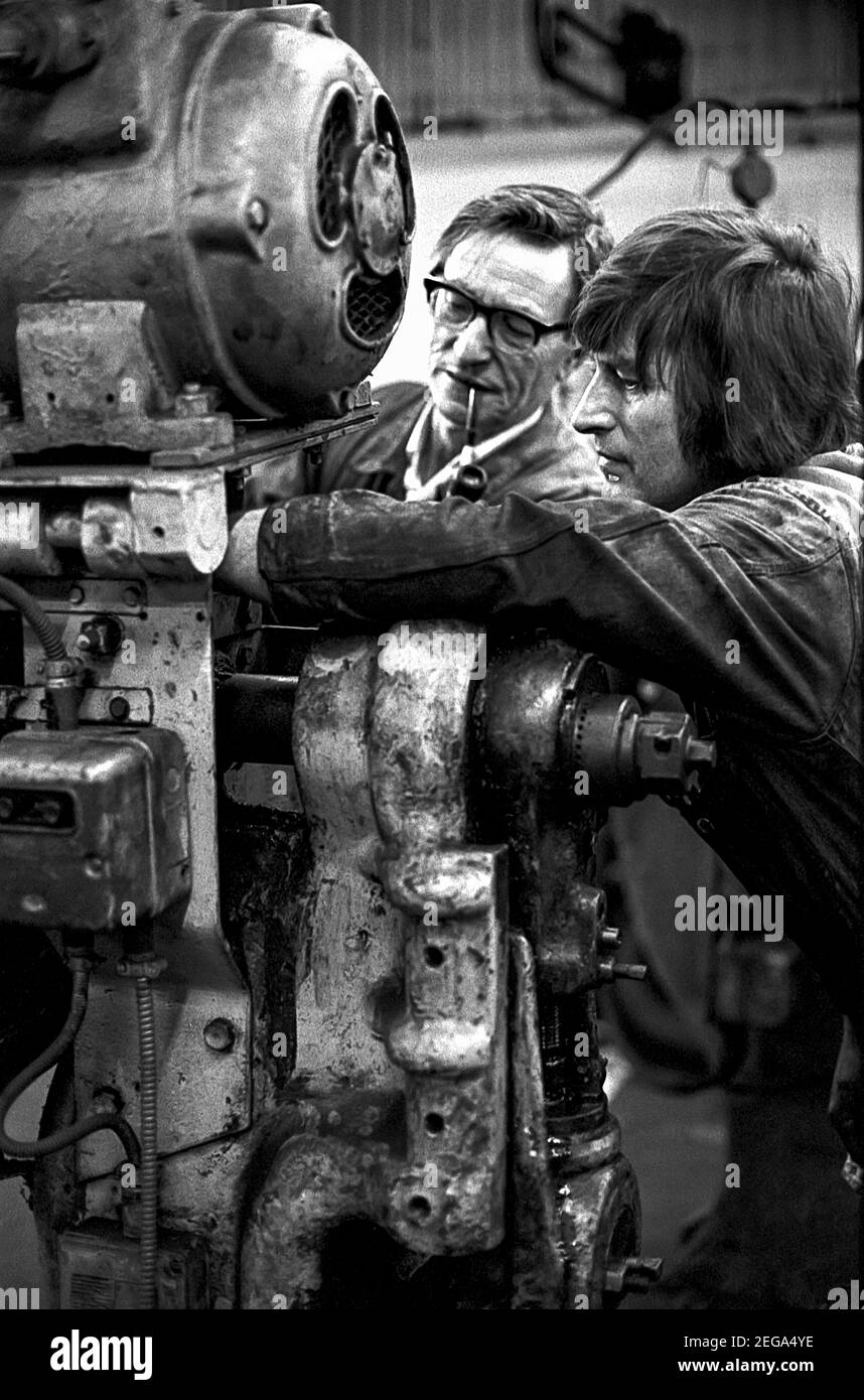 Two Engineers Working on Machine in Wrench Factory Stock Photo - Alamy