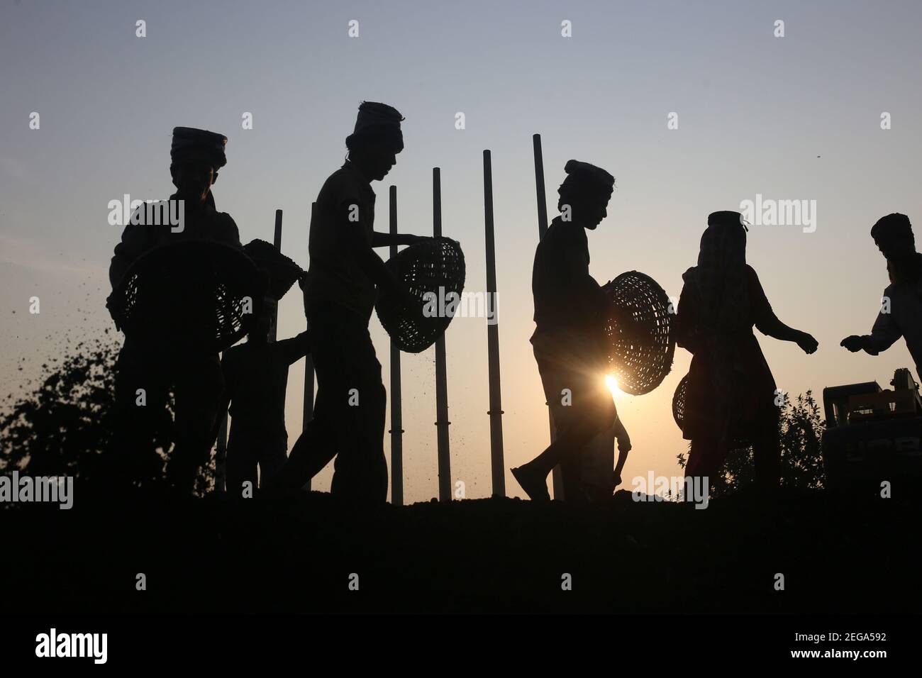 Dhaka, Bangladesh. 18th Feb, 2021. Day laborers silhouetted as they ...