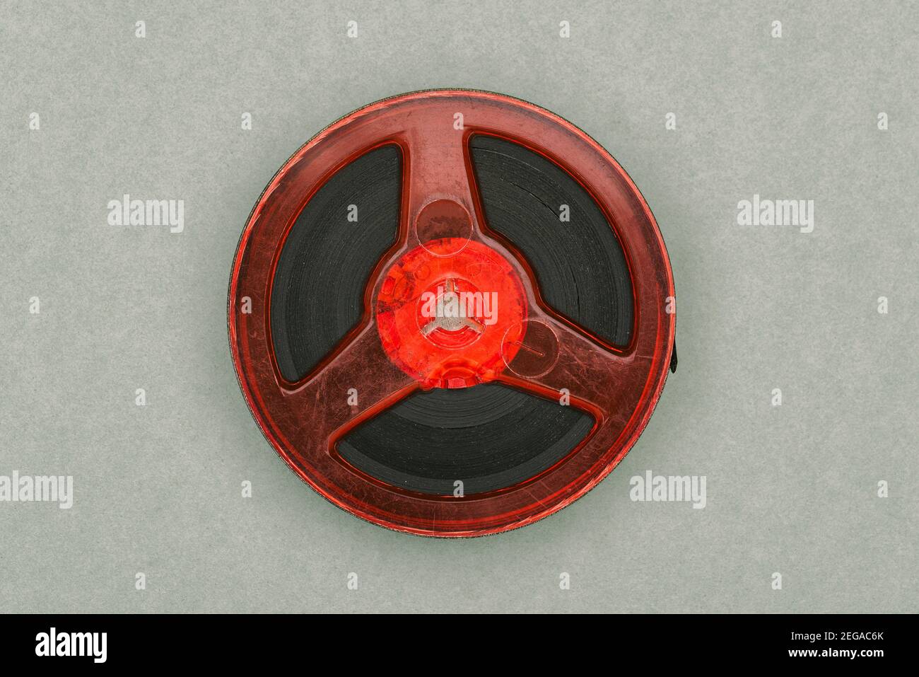 Film reel. Old round spool with red film. Magnetic foil. Retro movie ...