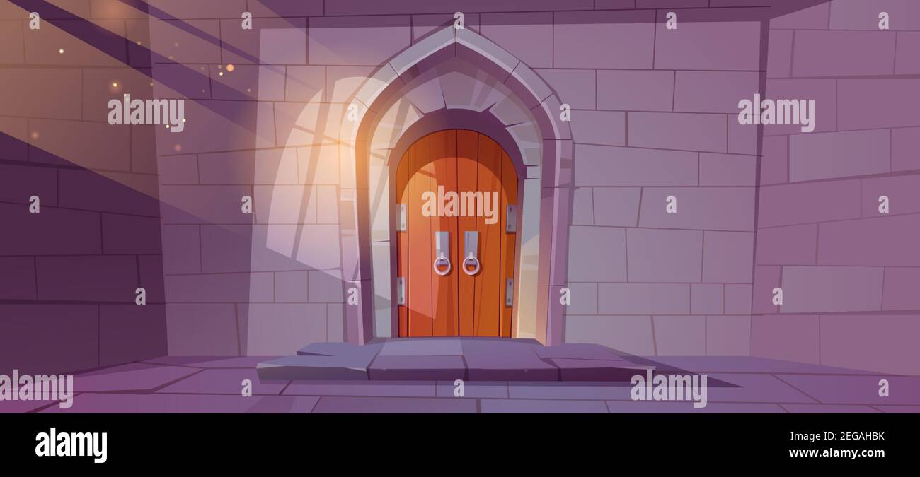 Medieval dungeon or castle interior with wooden arched door and wall of ...