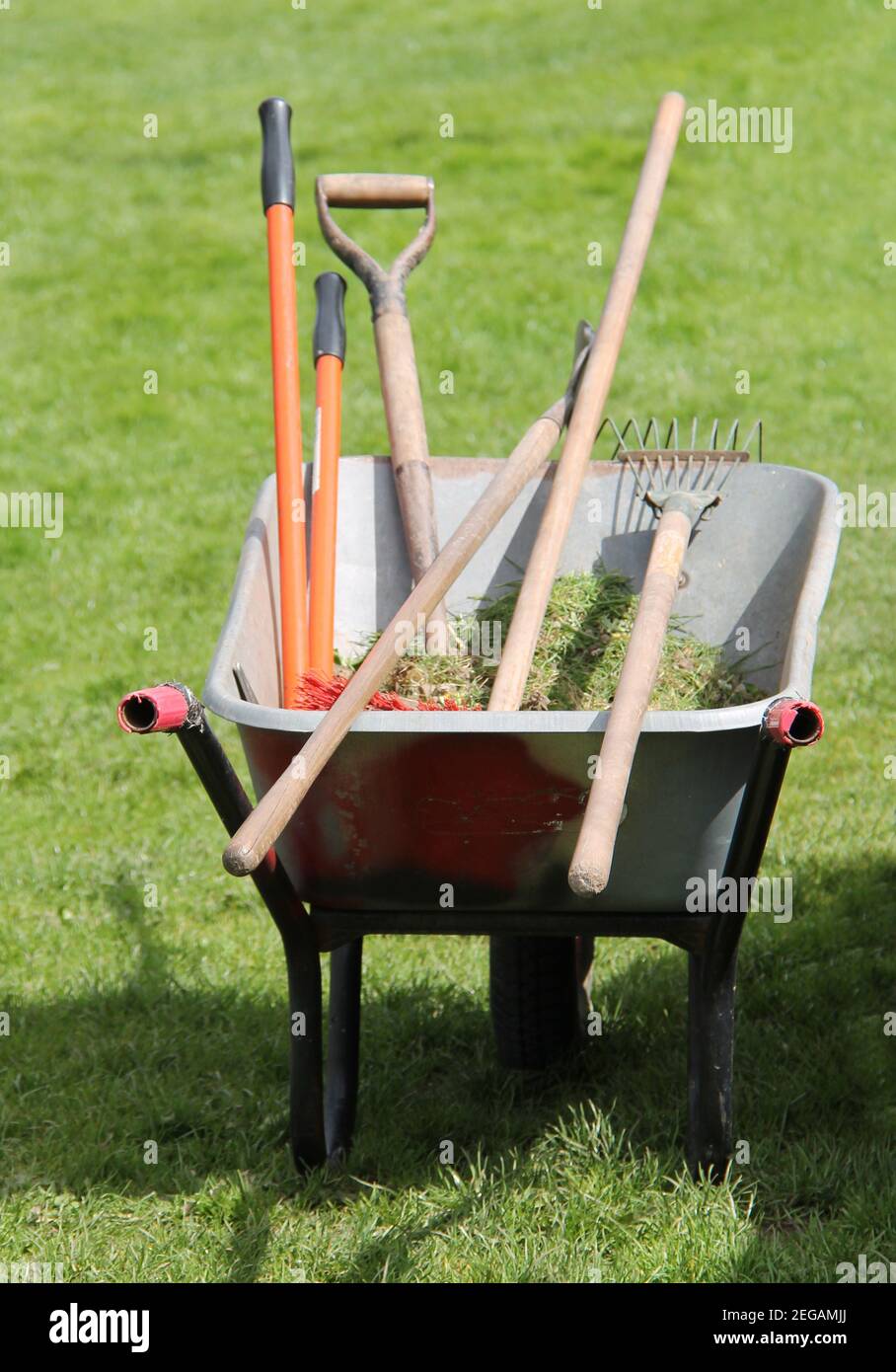 A Wheelbarrow with a Collection of Garden Tools Stock Photo - Alamy