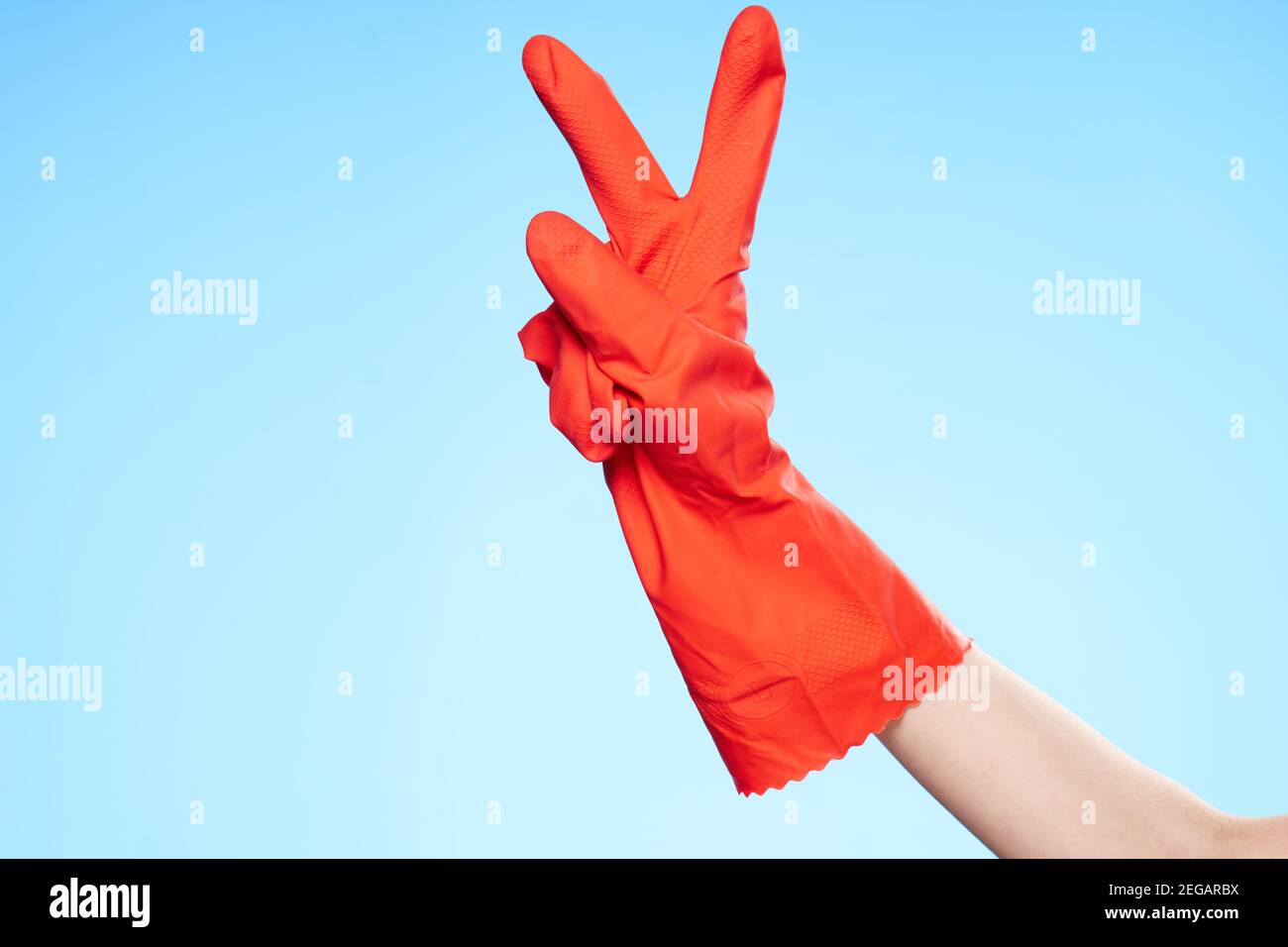 hand in red rubber gloves gesturing blue background cleaning Stock ...