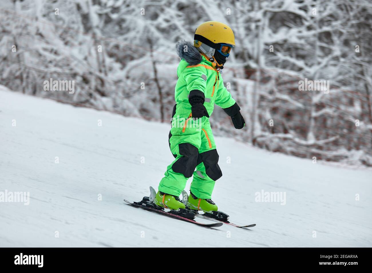 Child skiing in mountains. Active toddler kid with safety helmet ...