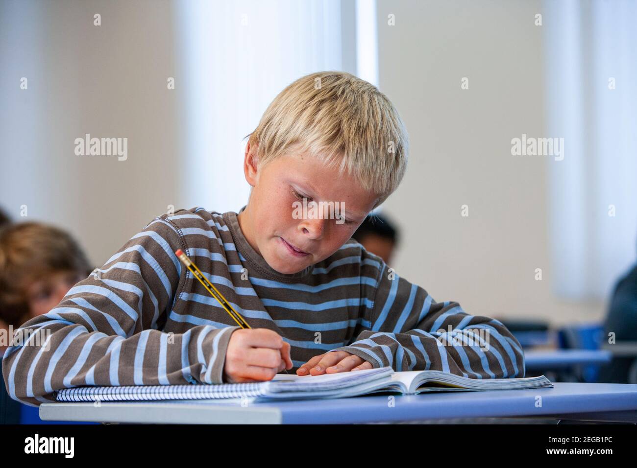 Young boy in the school classroom Stock Photo - Alamy