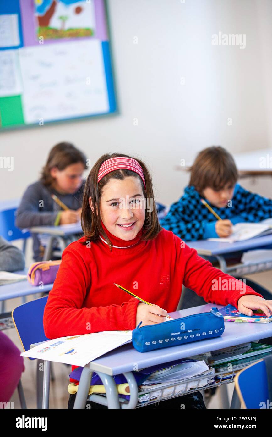 Young girl studying in a school classroom Stock Photo - Alamy