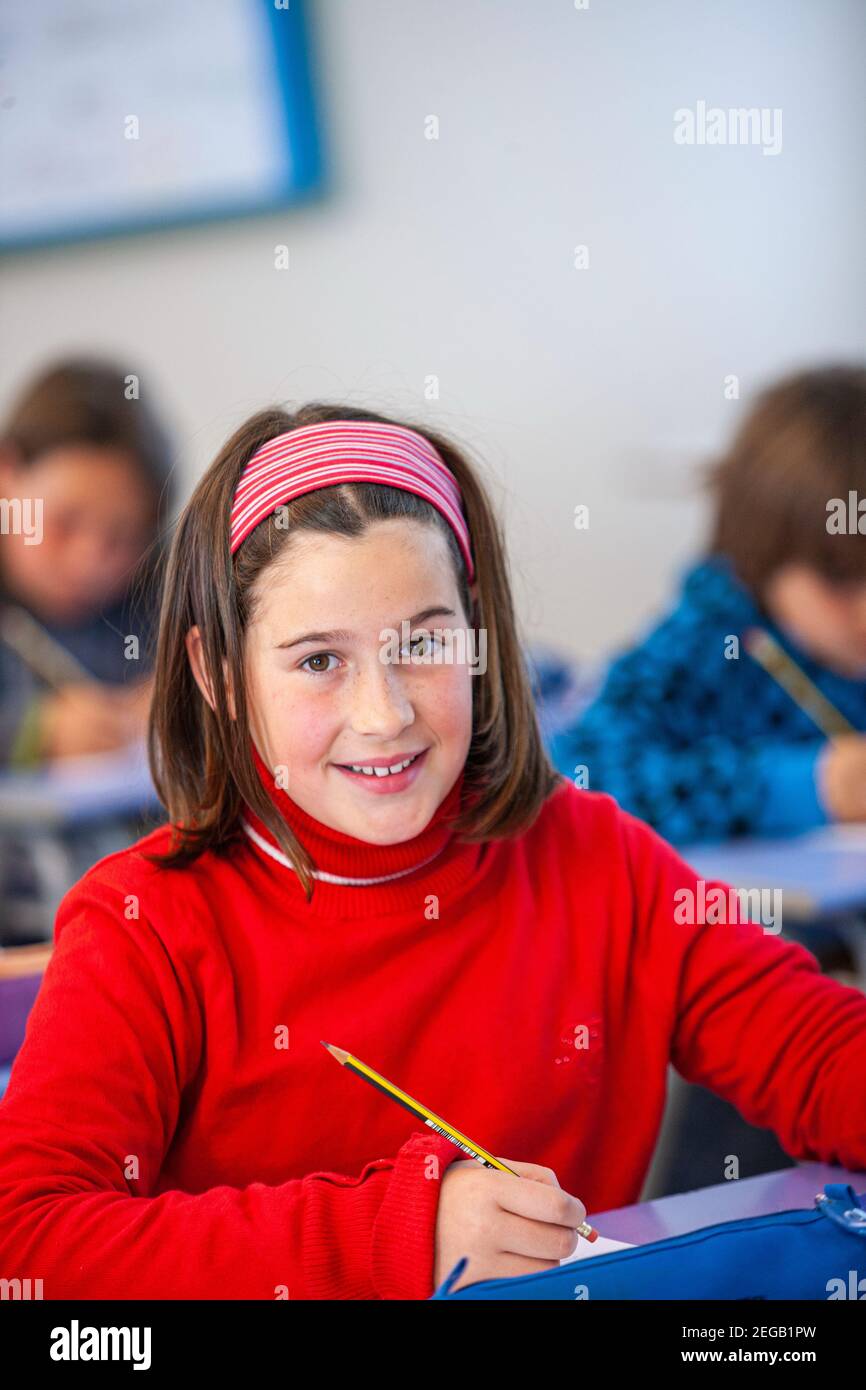 Young girl studying in a school classroom Stock Photo - Alamy