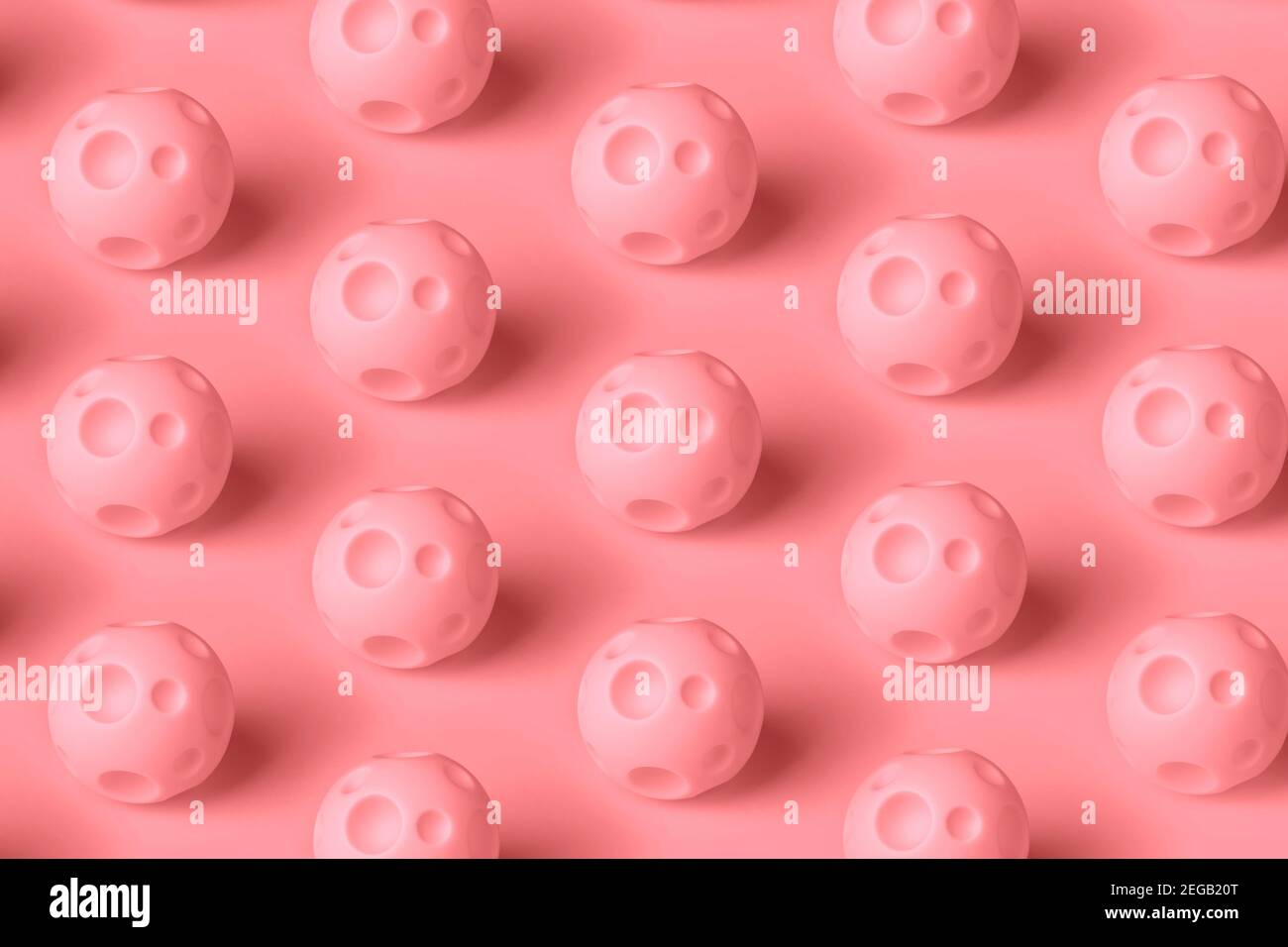 mars pattern over pink background, toy ball with craters on a bright ...