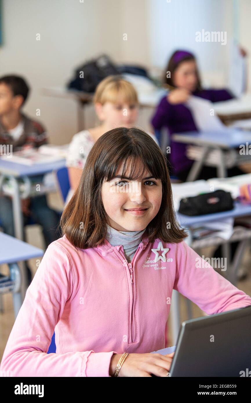 Young girl studying in a school classroom Stock Photo - Alamy