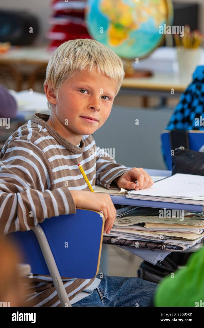 Young boy in a school classroom Stock Photo - Alamy