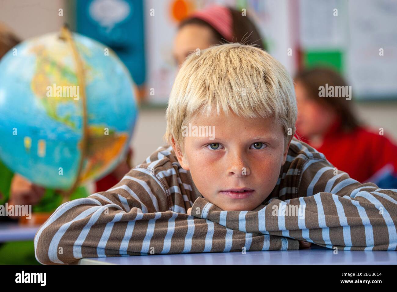 Young boy in a school classroom Stock Photo - Alamy