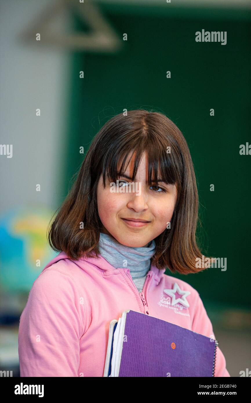 Young girl studying in a school classroom Stock Photo - Alamy