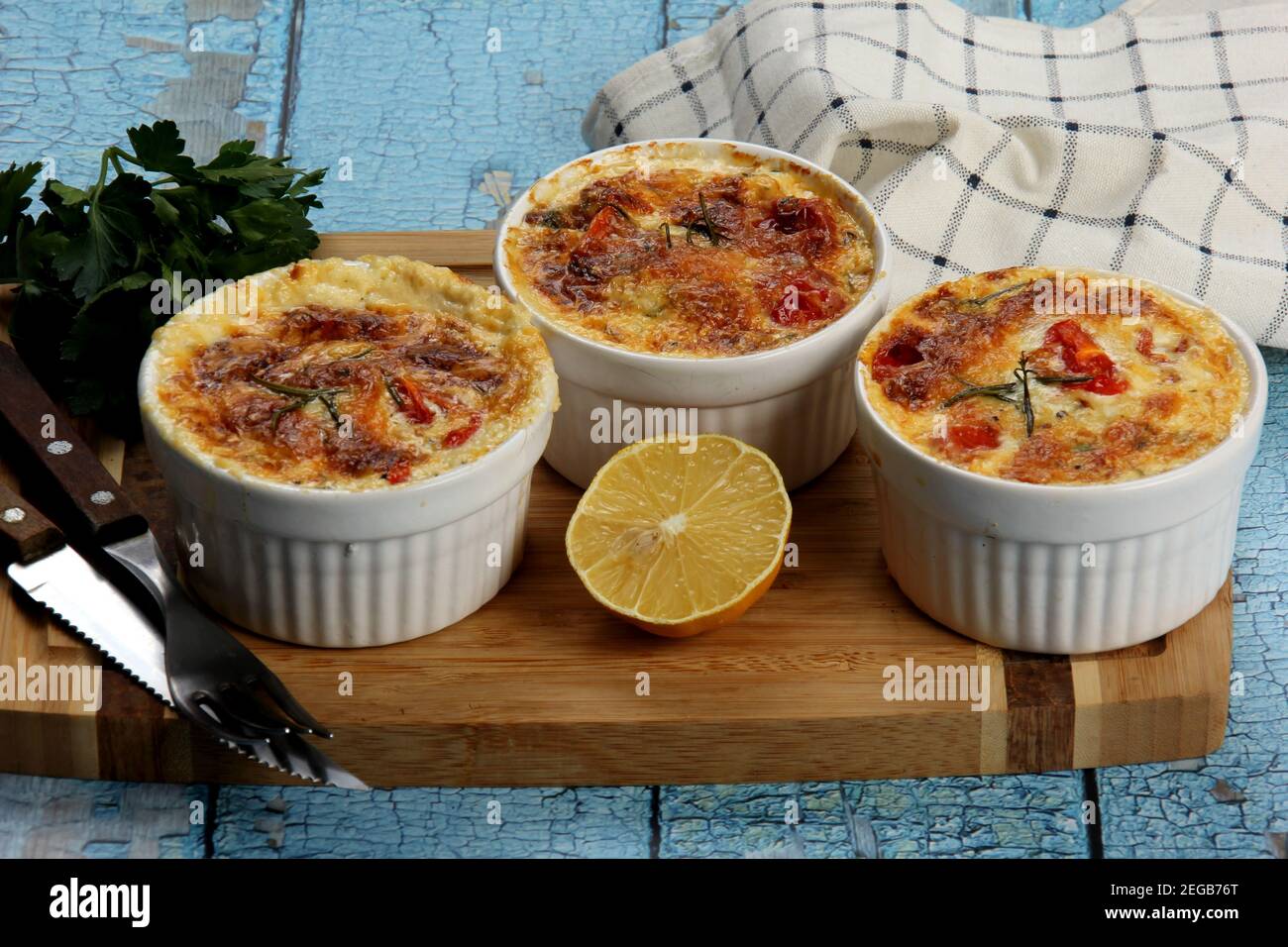 Cod casserole with cheese, sour cream and tomatoes. White fish ...