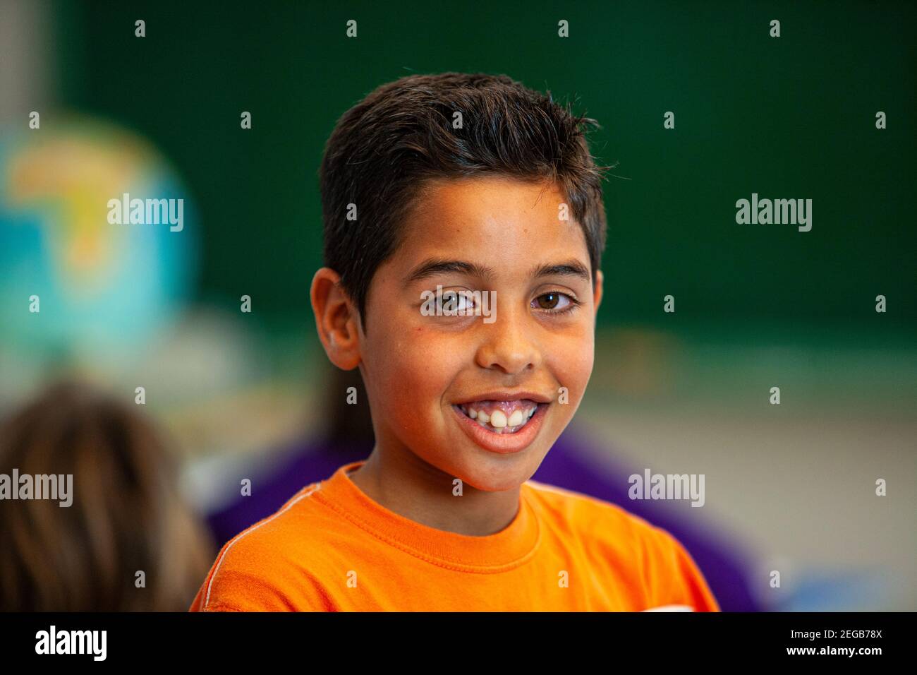 Young boy in a school classroom Stock Photo - Alamy