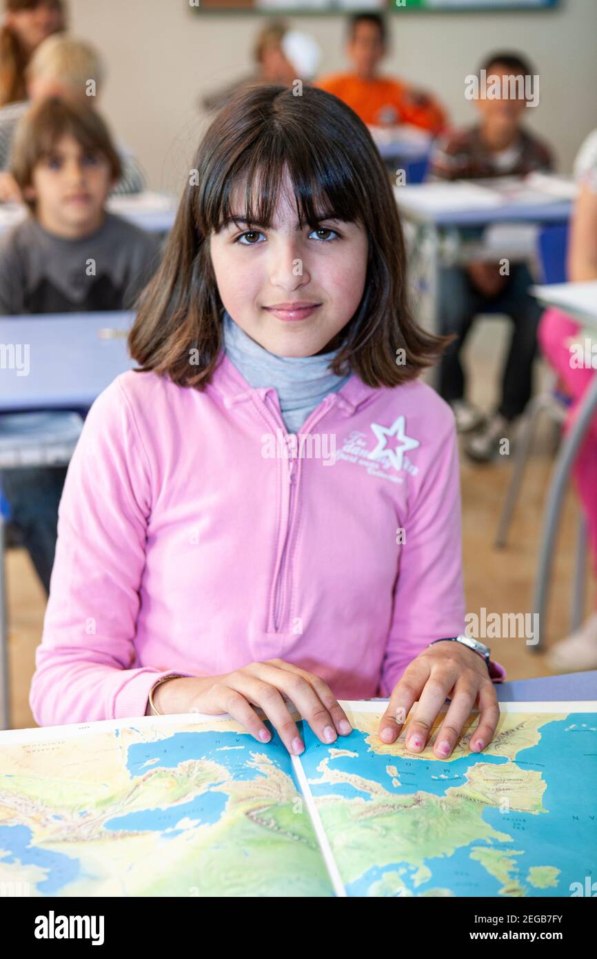 Young girl studying in a school classroom Stock Photo - Alamy
