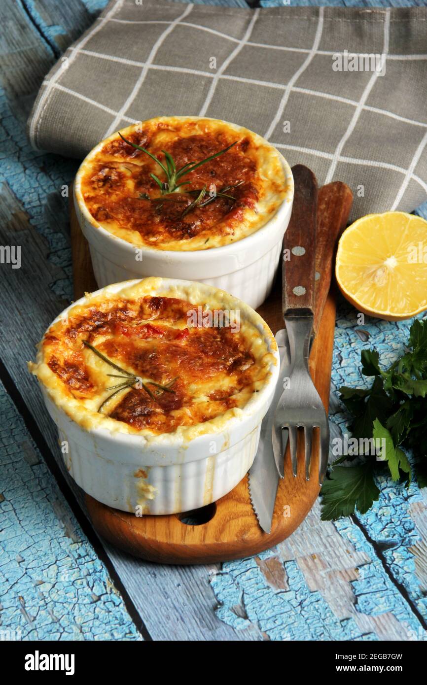 Cod casserole with cheese, sour cream and tomatoes. White fish ...