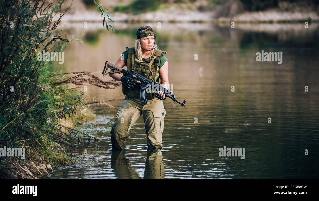 Water survival training. Female military army soldier with machine gun ...