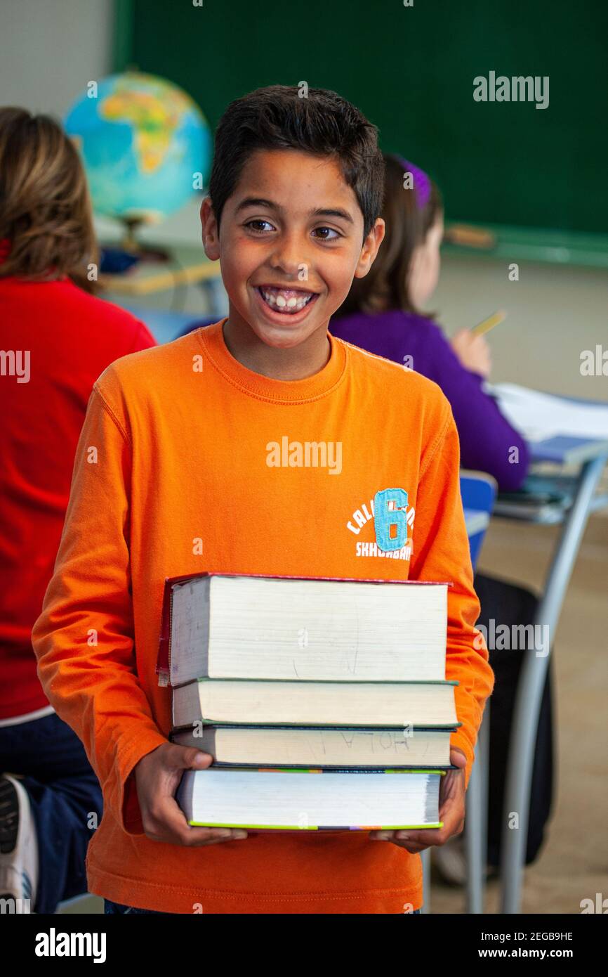 Happy young boy in a school classroom Stock Photo - Alamy