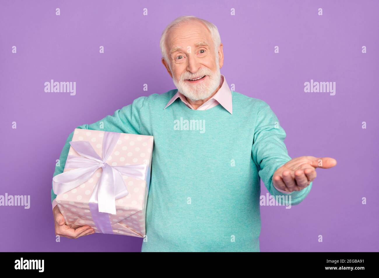 Photo portrait of senior man keeping present box with present smiling ...