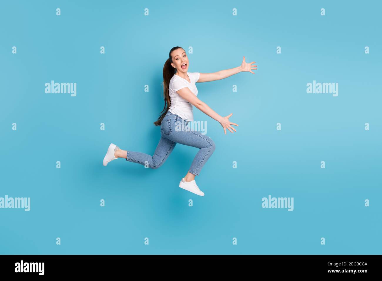 Full length profile side photo of energetic girl greet her friend jump ...