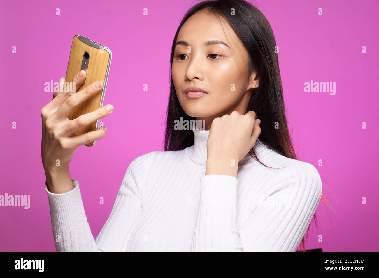 asian woman holding phone he communication technology internet pink ...