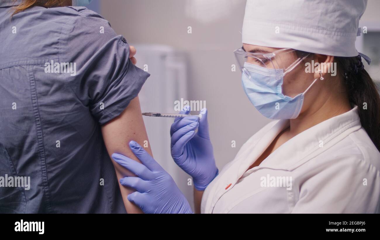 Medical Nurse in Safety Gloves and Protective Mask is Making a Vaccine ...