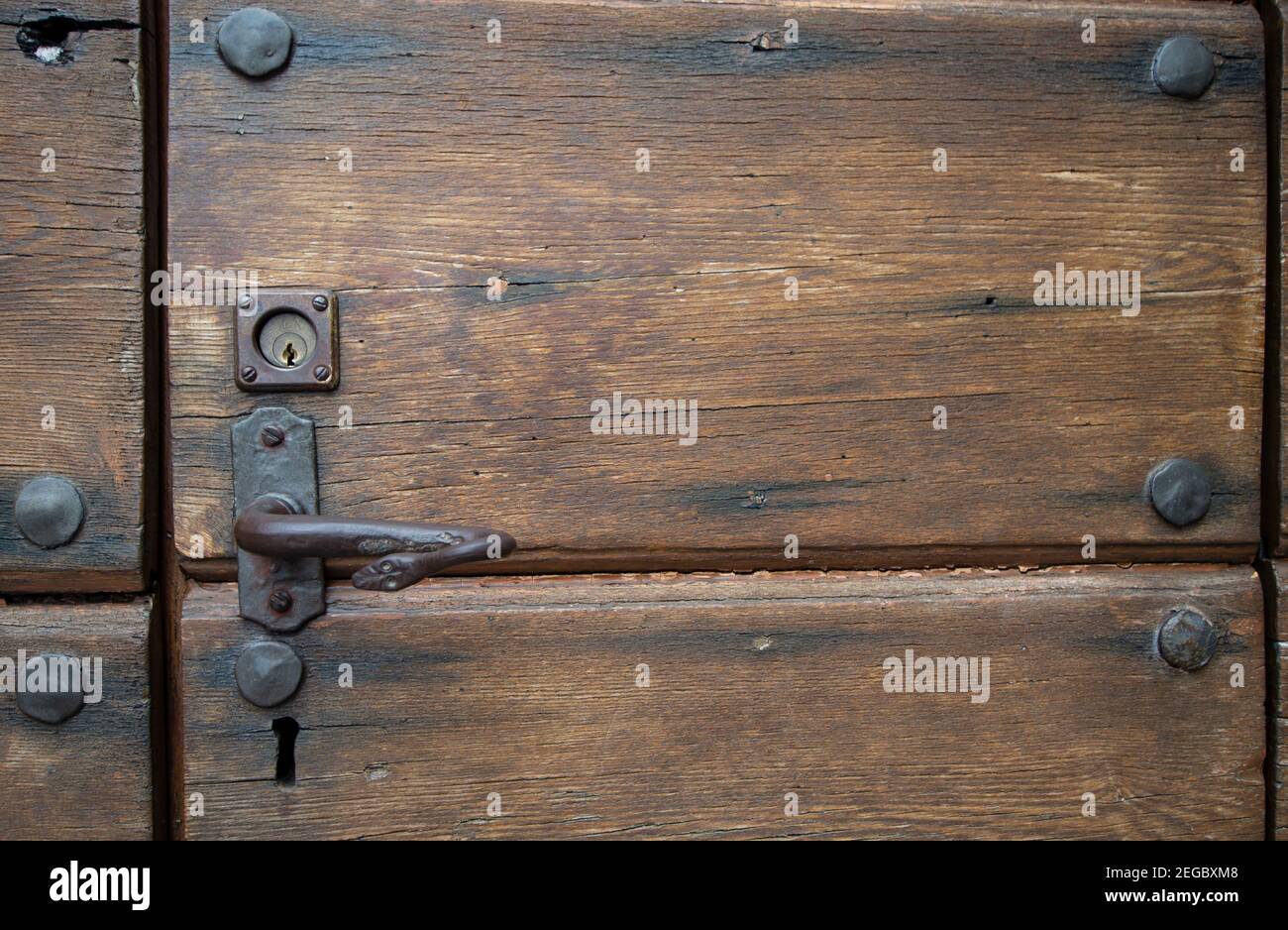 old wooden door with snake-shaped handle Stock Photo - Alamy