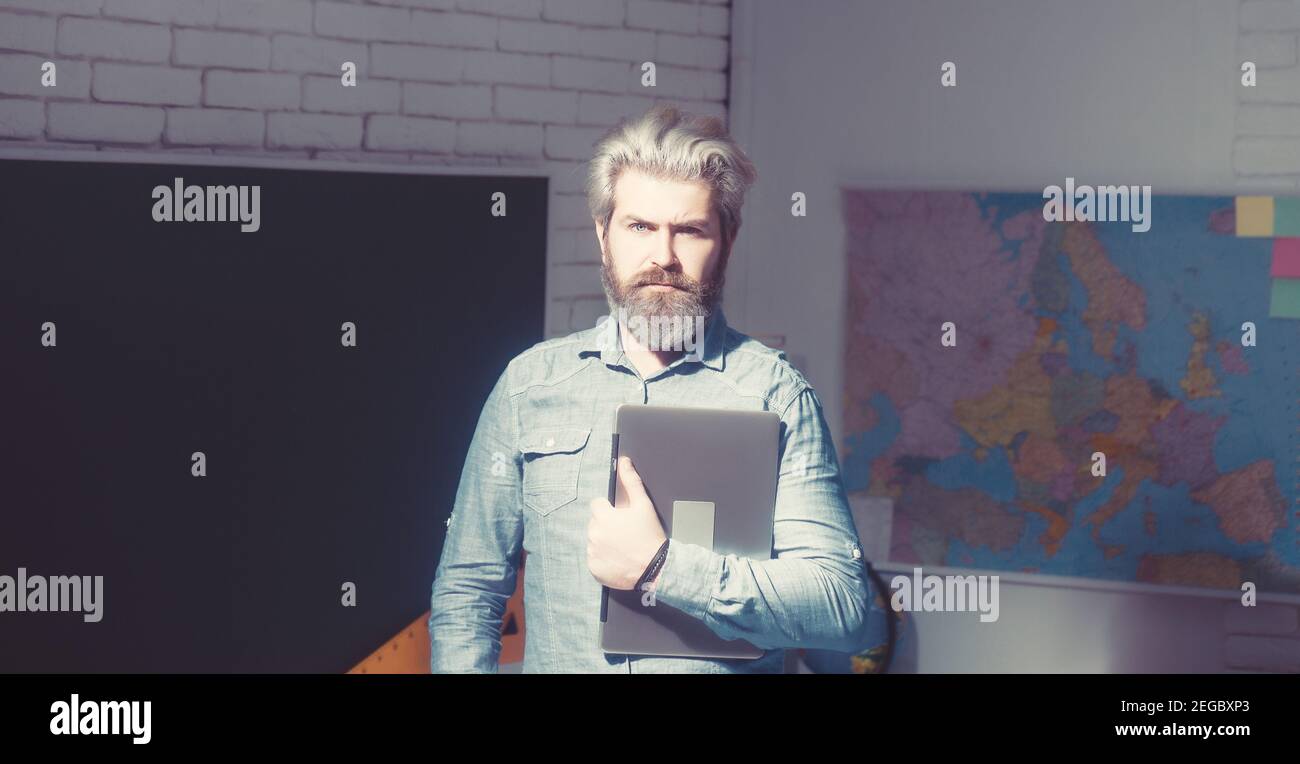 Teacher posing in her classroom hi-res stock photography and images - Alamy