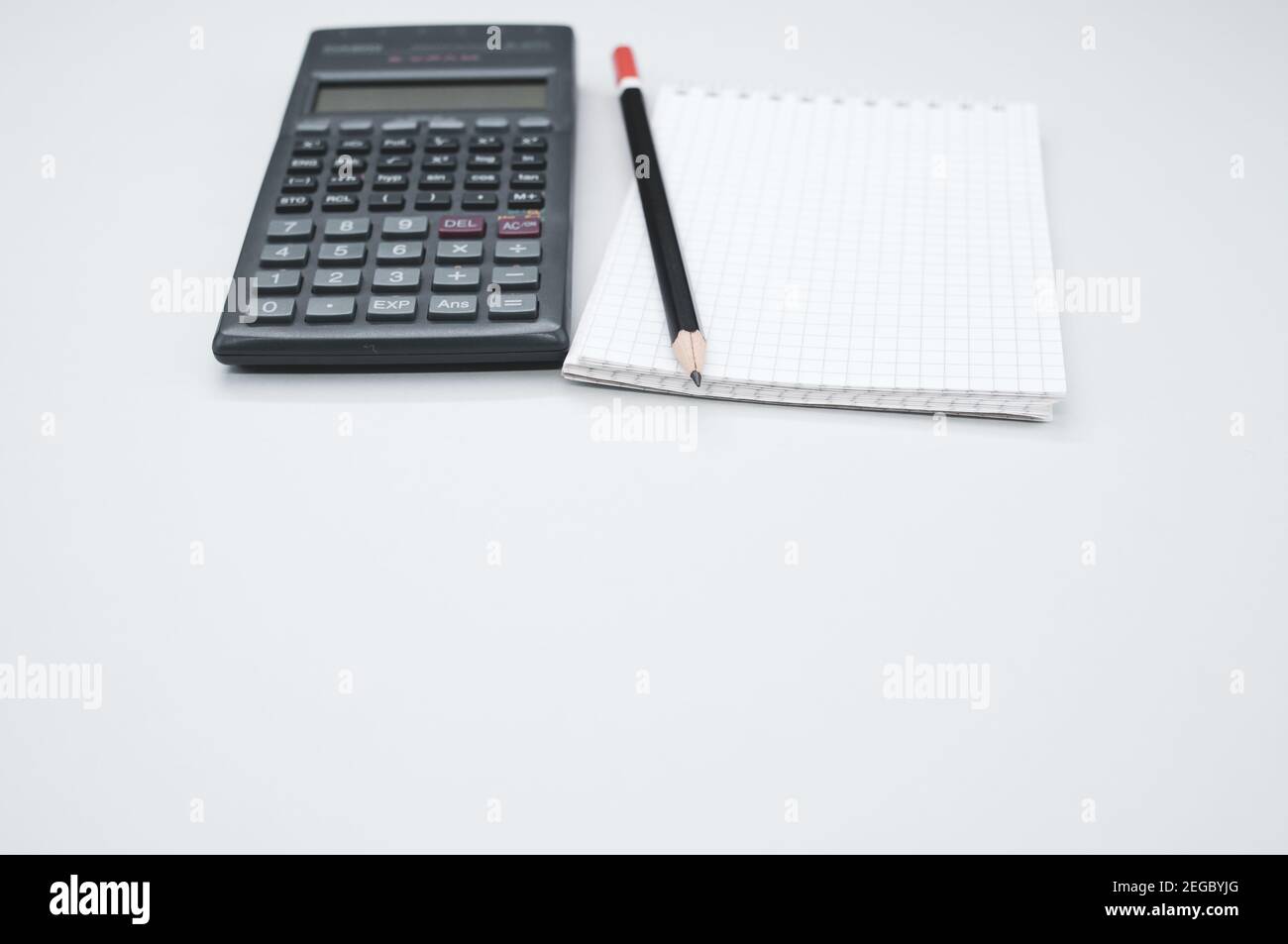 Closeup shot of a scientific calculator, pencil, and math notepad ...