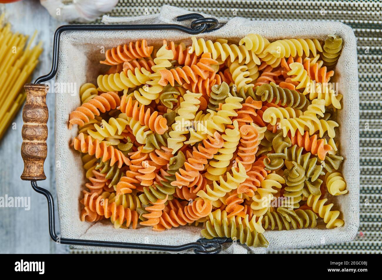 Colorful uncooked pasta in a basket. Top view Stock Photo - Alamy