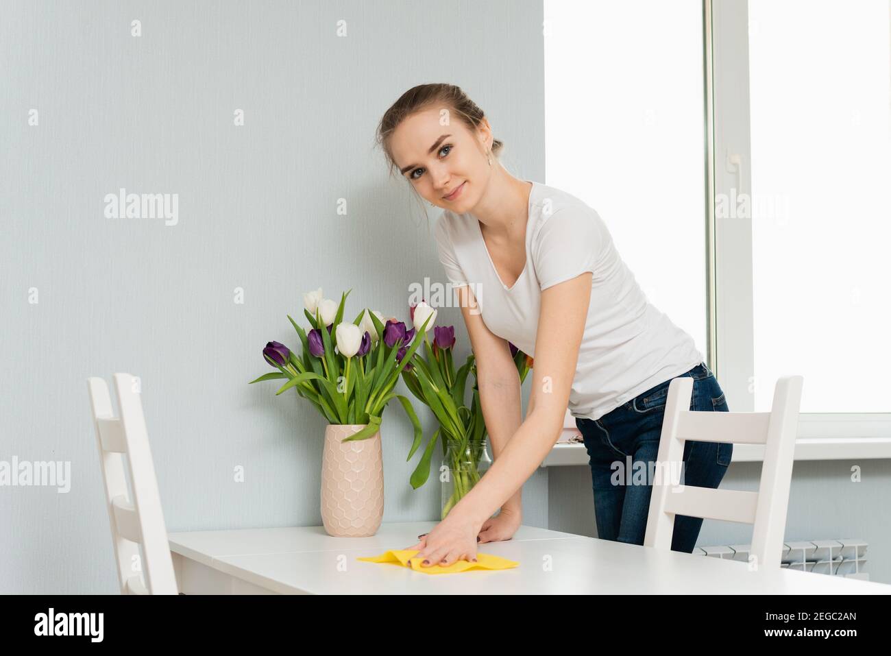 Housewife wiping dust off the table. woman make daily house chores dust ...