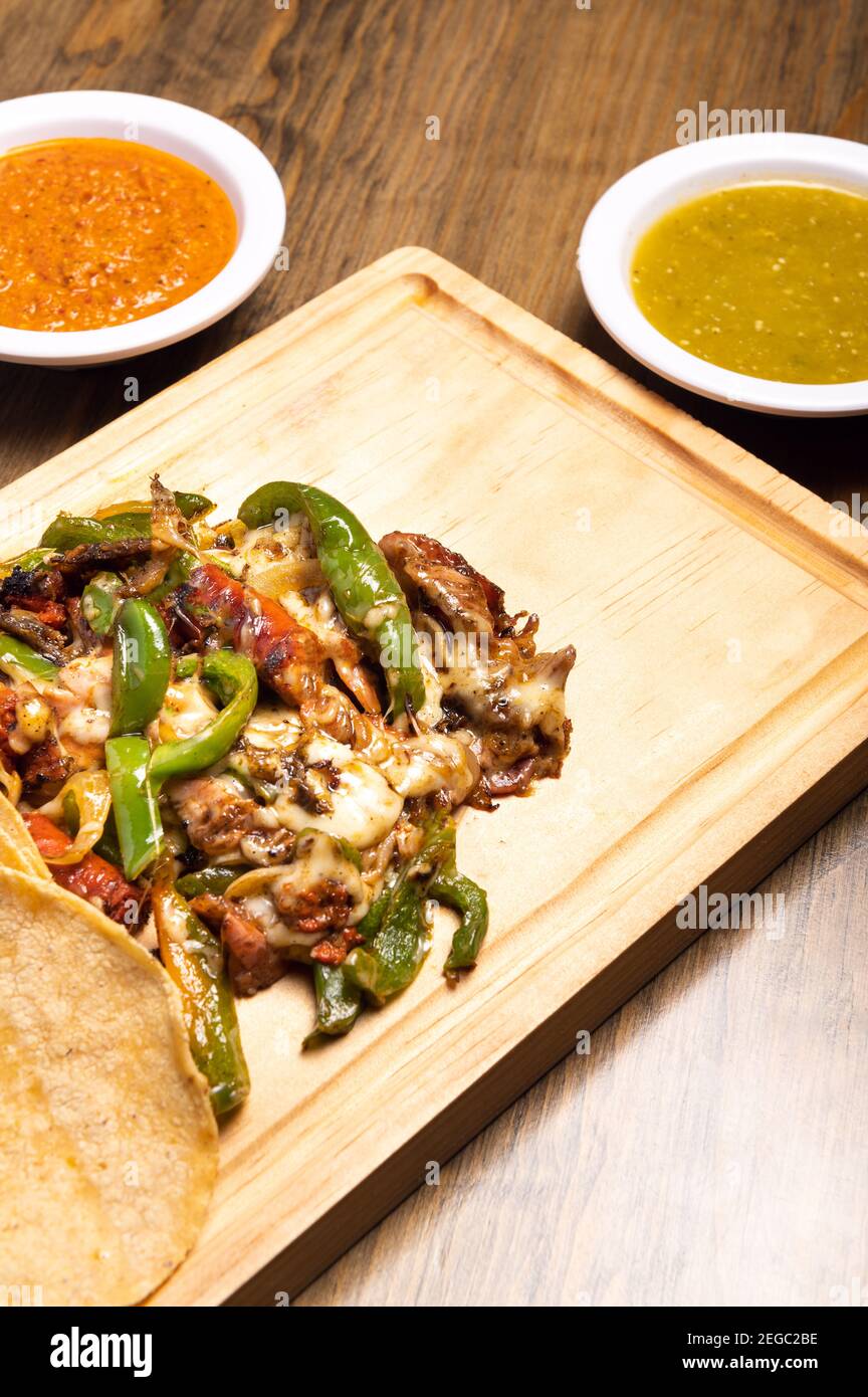 Top view of Traditional Mexican food (Chistorra tacos with cheese) on a ...