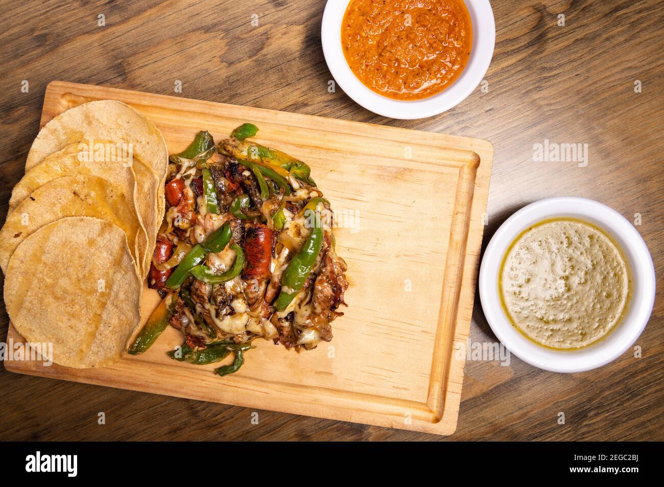 Top view of Traditional Mexican food (Chistorra tacos with cheese) on a ...