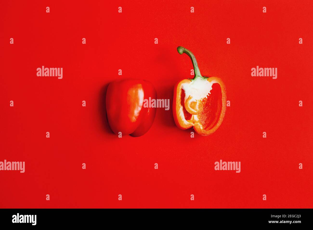 top view of red bell pepper cut in half on red background Stock Photo ...