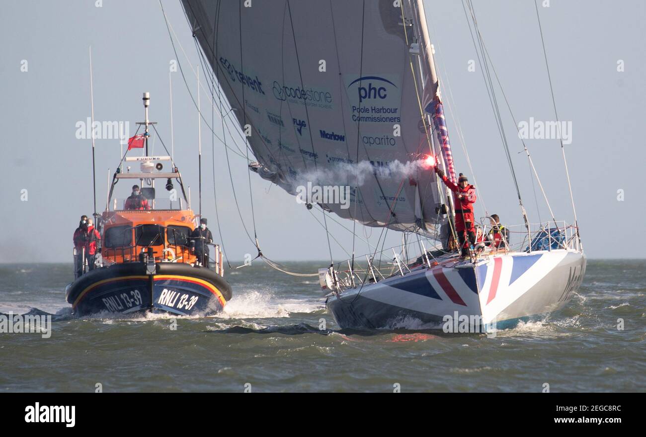Pip Hare sets off a flare as she sails her boat Medallia into Poole, Dorset, after completing ...