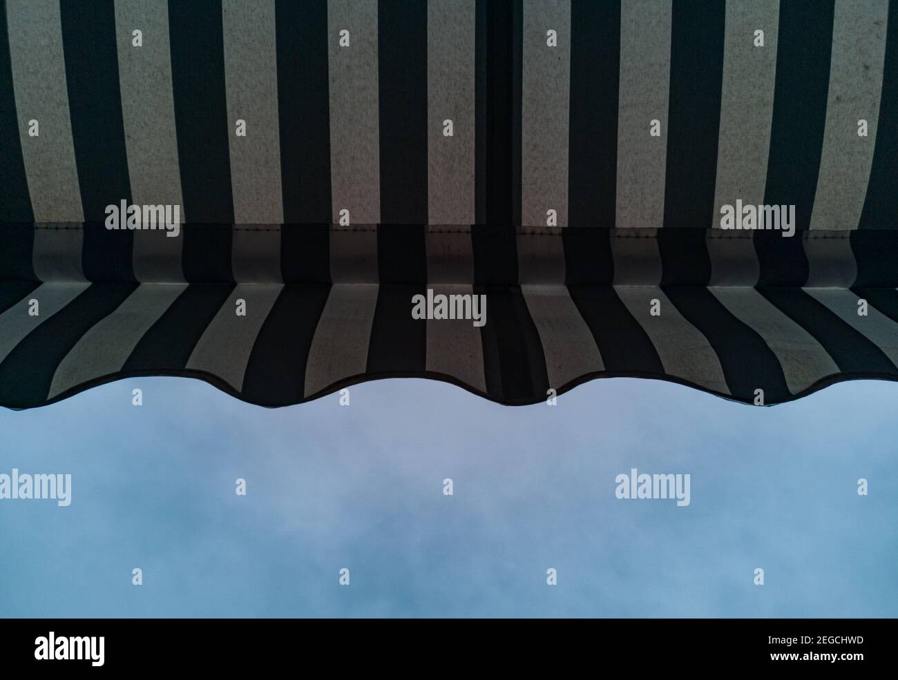 Upward view to shop awning with black and white stripes Stock Photo - Alamy