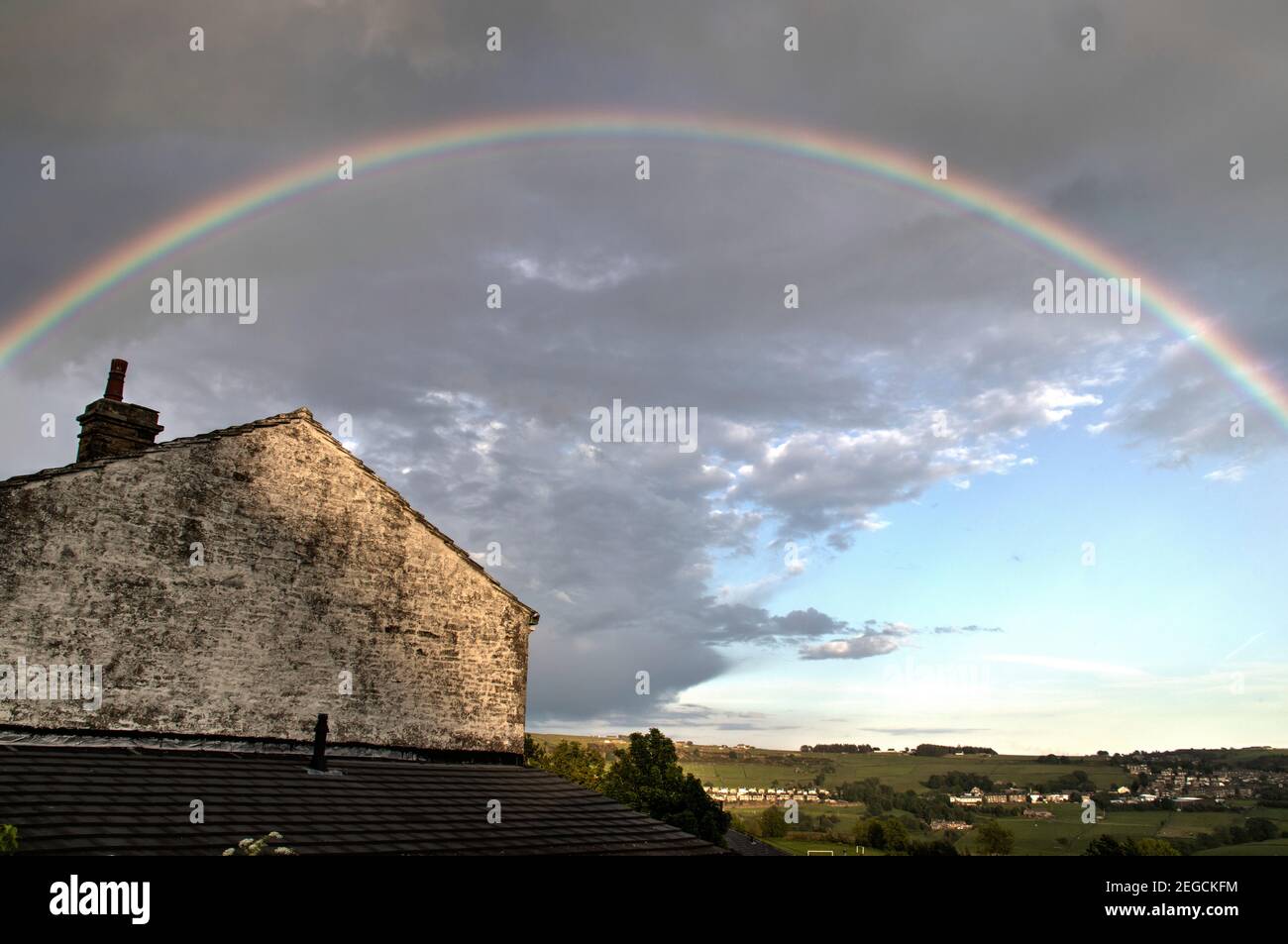 Rainbow over old white house Stock Photo - Alamy