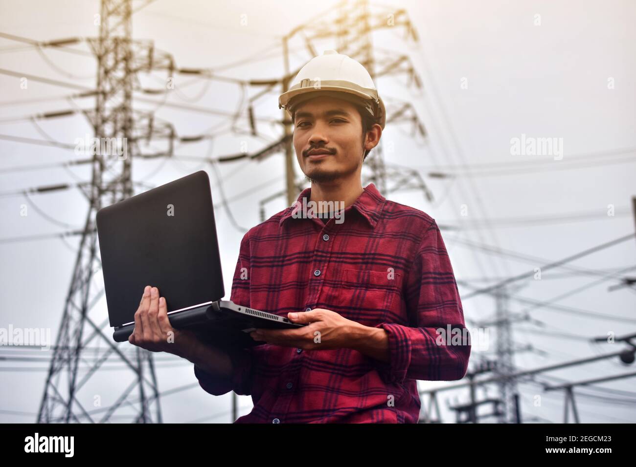 Engineer hold laptop computer inspection on site power plant high volte ...
