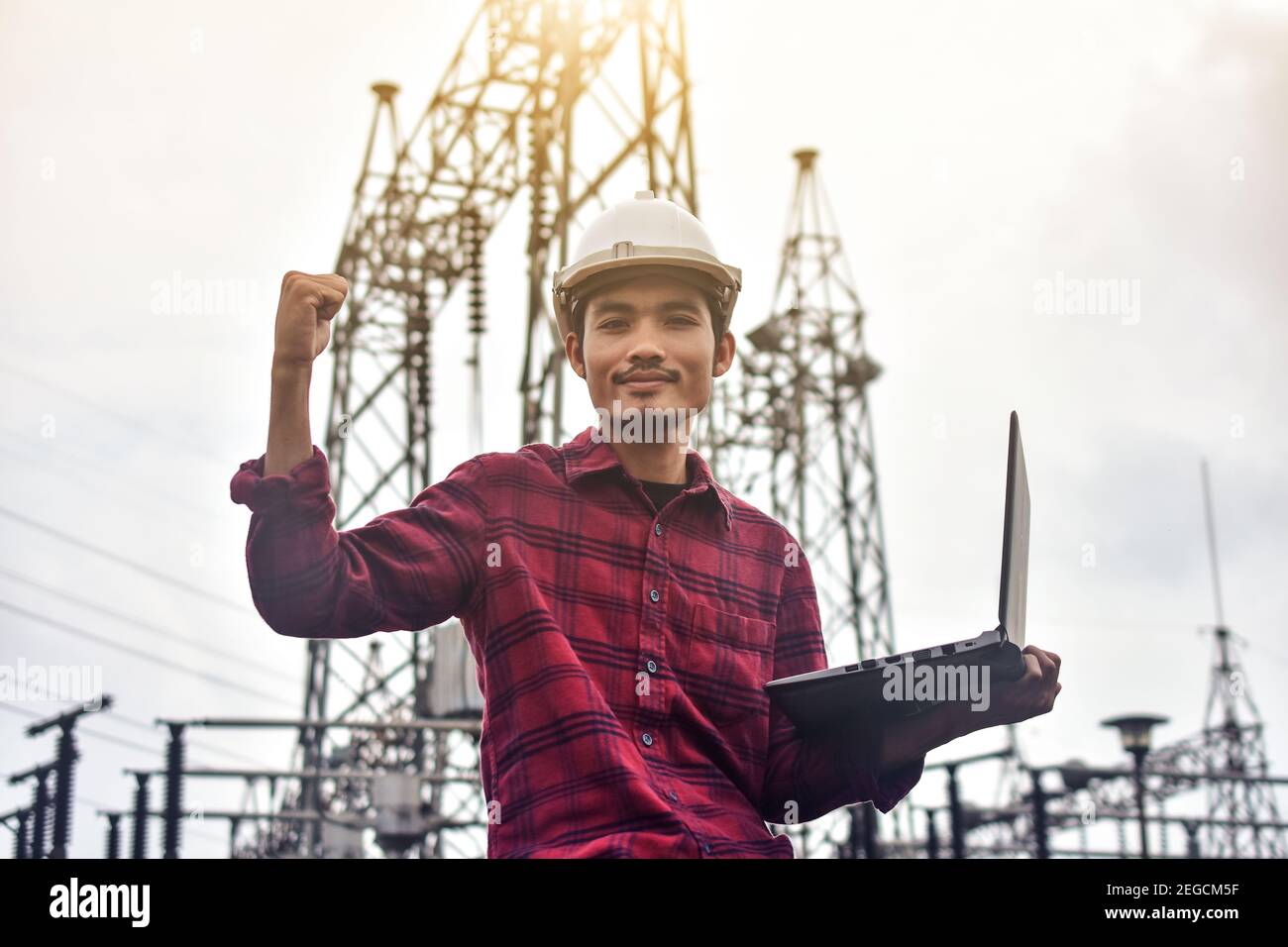 Engineer hold laptop computer inspection on site power plant high volte ...