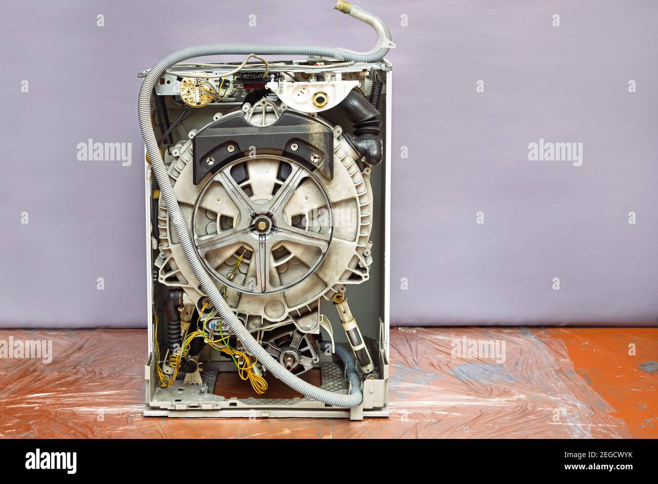disassembled washing machine. repairs. grey background Stock Photo - Alamy
