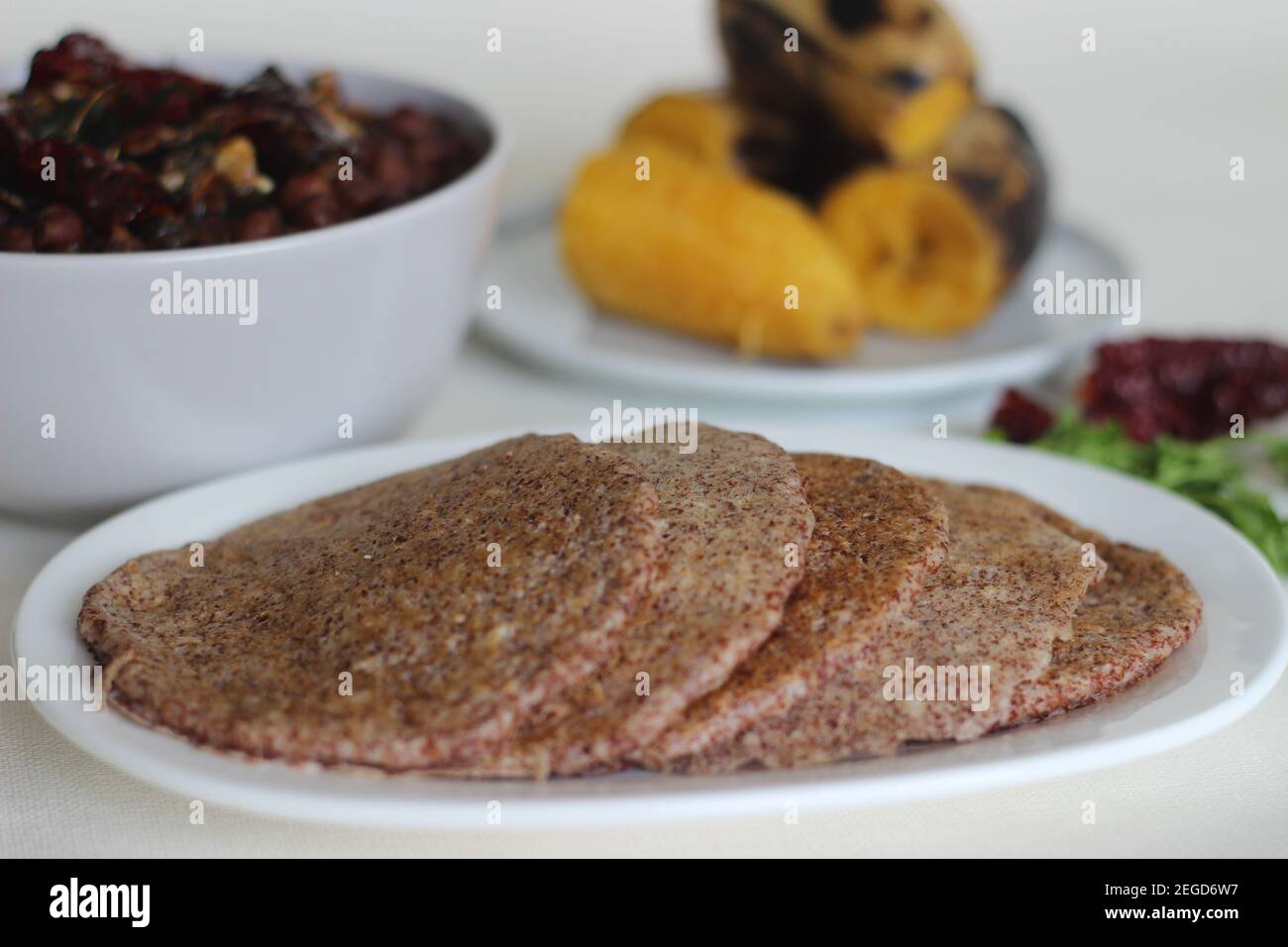 Home made Finger millet pancakes served with black chickpea gravy and ...