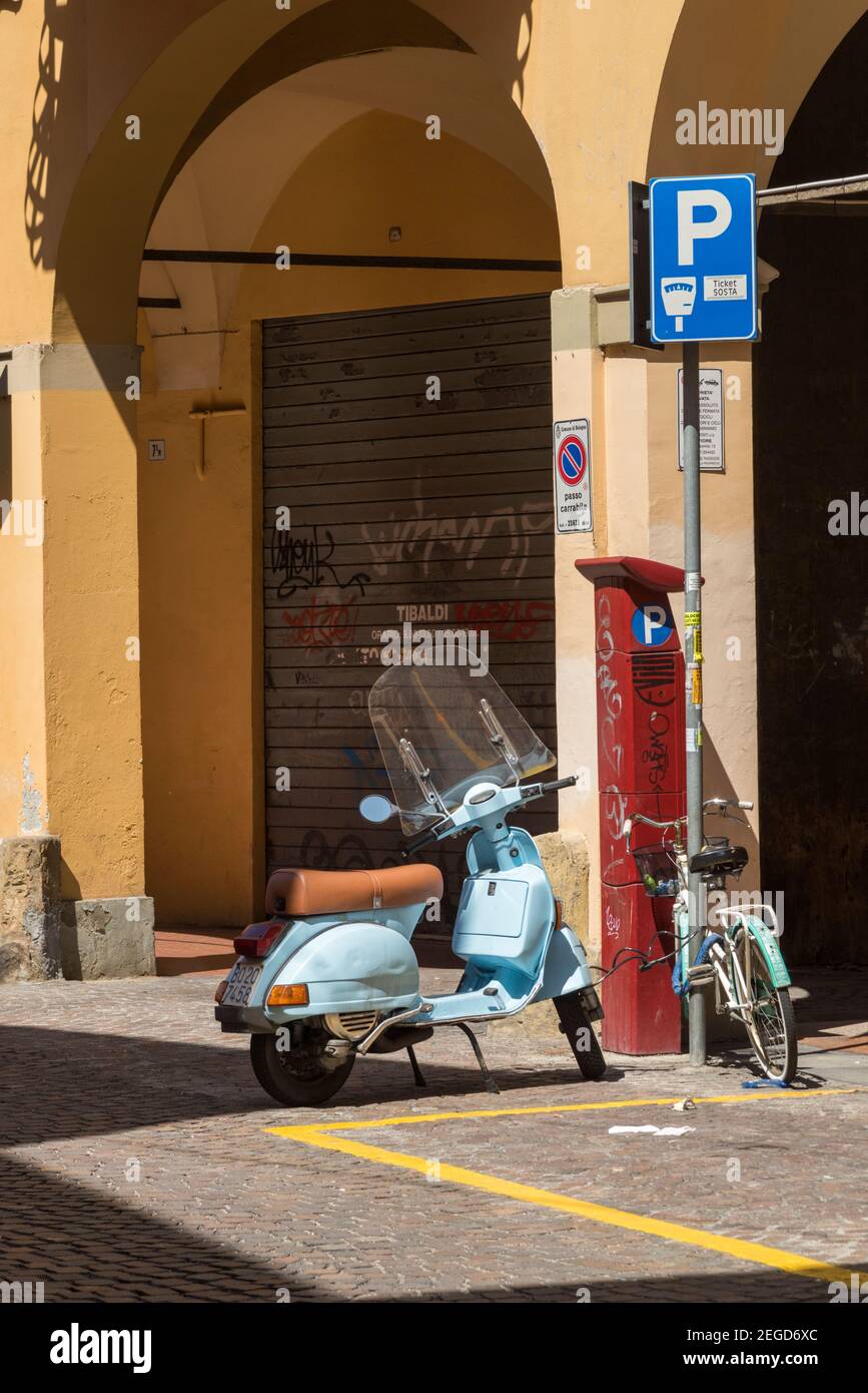 A light blue vespa scooter parked in a street in Bologna Italy Stock ...