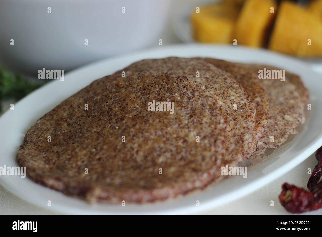 Home made Finger millet pancakes served with black chickpea gravy and ...