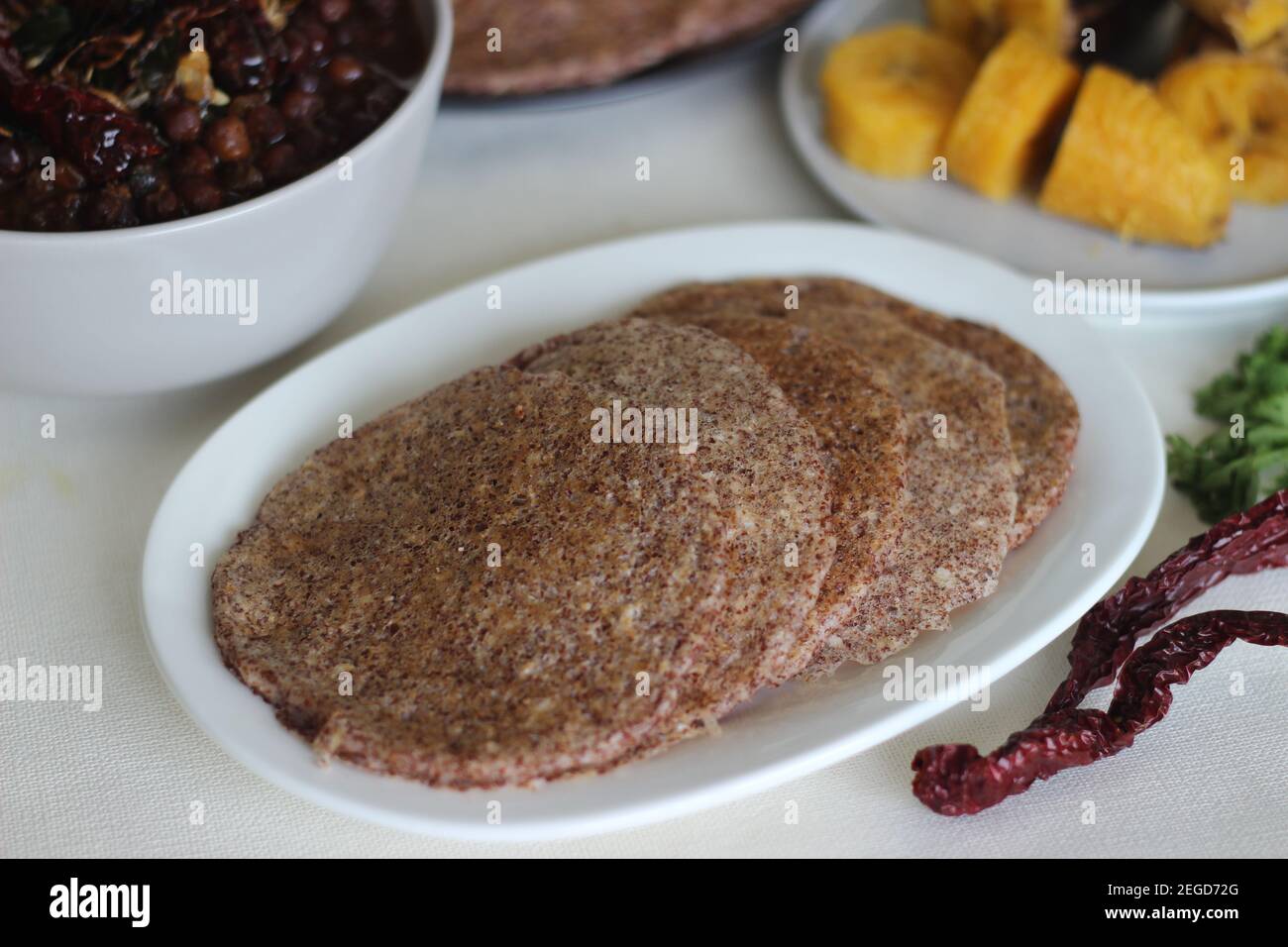 Home made Finger millet pancakes served with black chickpea gravy and ...